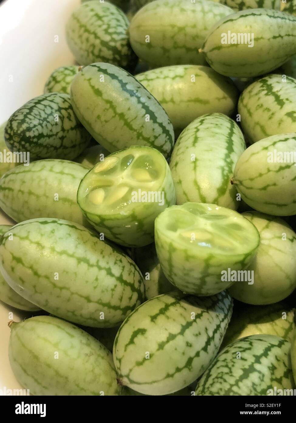 A harvest of fresh cucamelons - tiny cucumbers that look like cherry ...