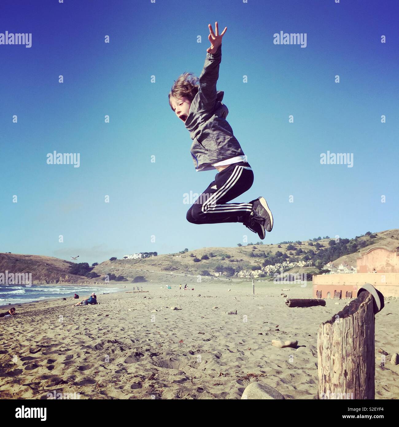 Boy jumping on the beach in California Stock Photo - Alamy