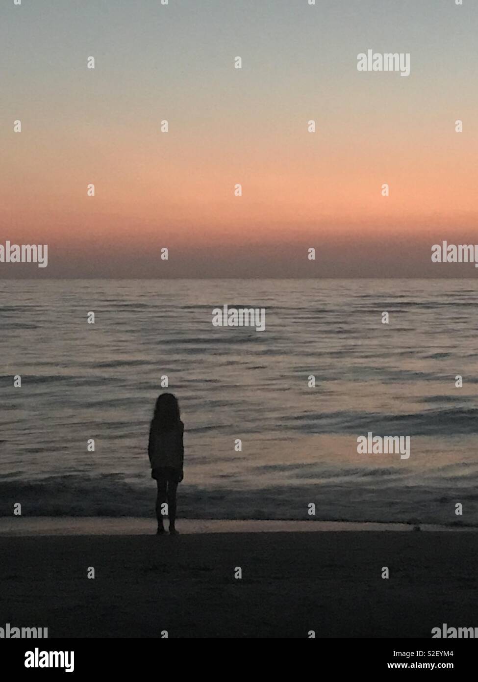 Little girl sunset watching Stock Photo - Alamy