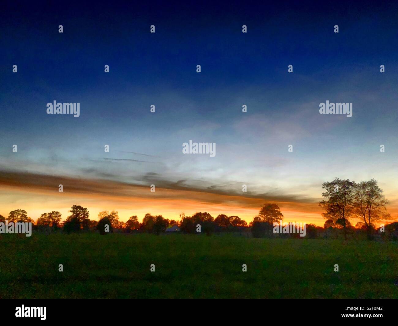 Colorful and dramatic fiery sky over a Countryside landscape Stock ...