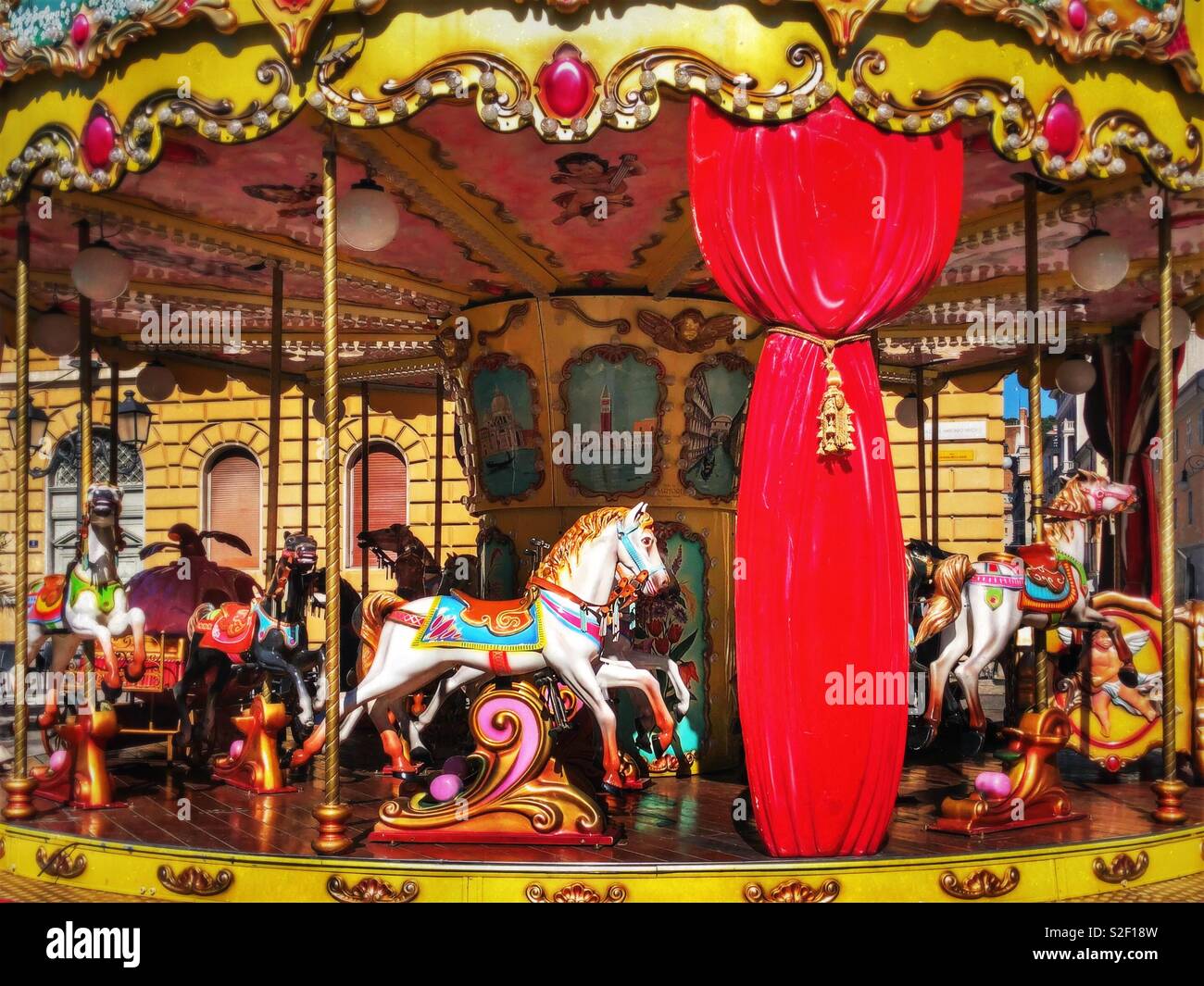 Colourful carousel on the street - Trieste, Italy Stock Photo - Alamy