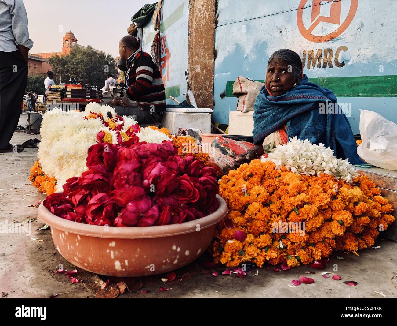 An old lady selling flowers near the HAWA MAHAL in jaipur India Stock ...