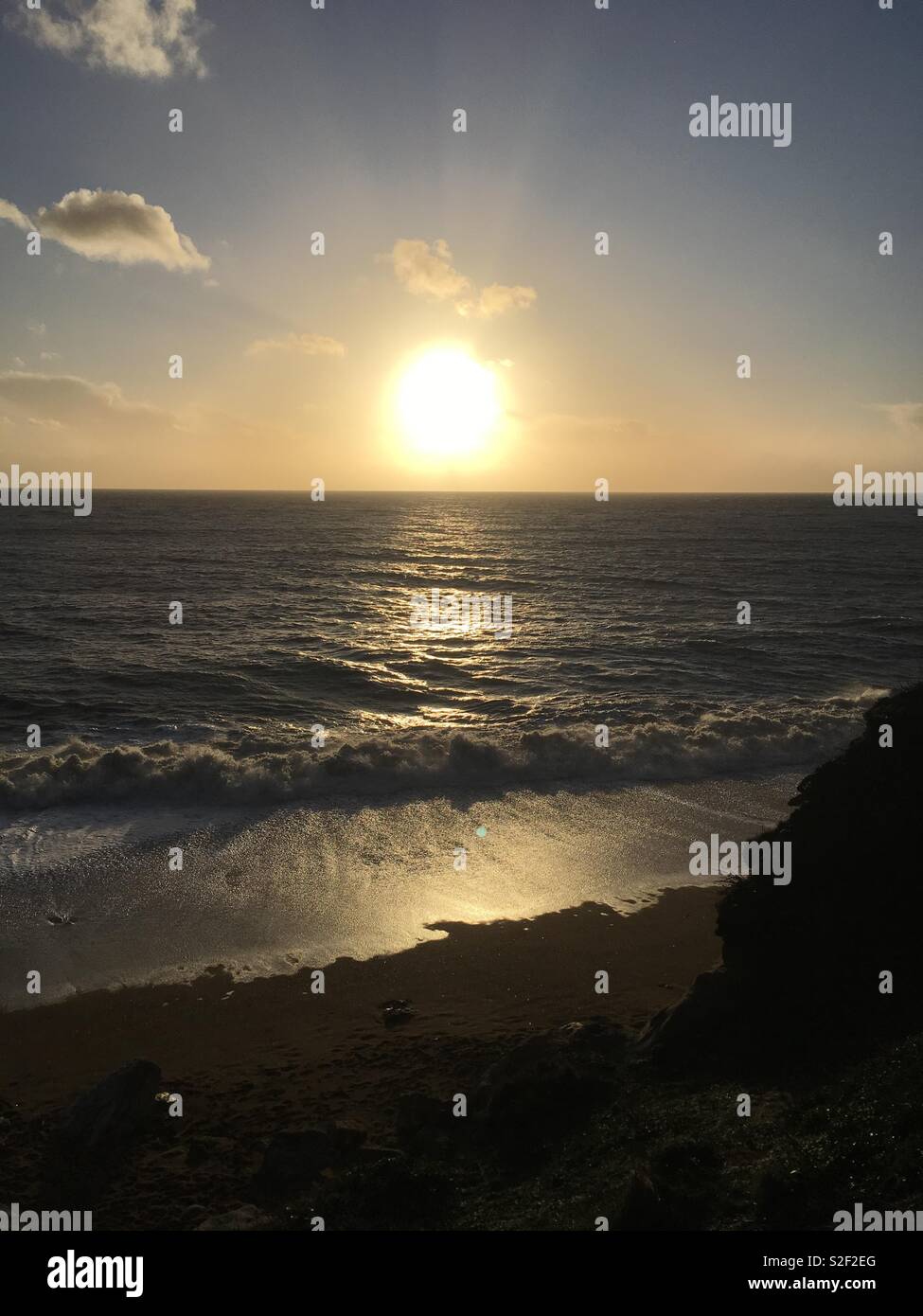 Beach with low sun Stock Photo - Alamy