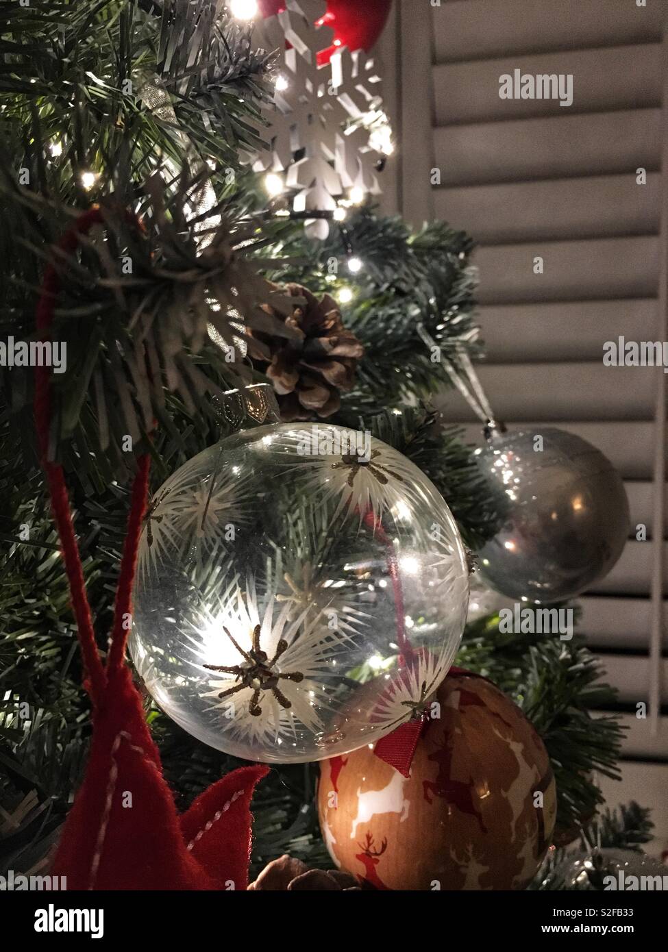Christmas decorations on a Christmas tree with a shutter behind Stock ...