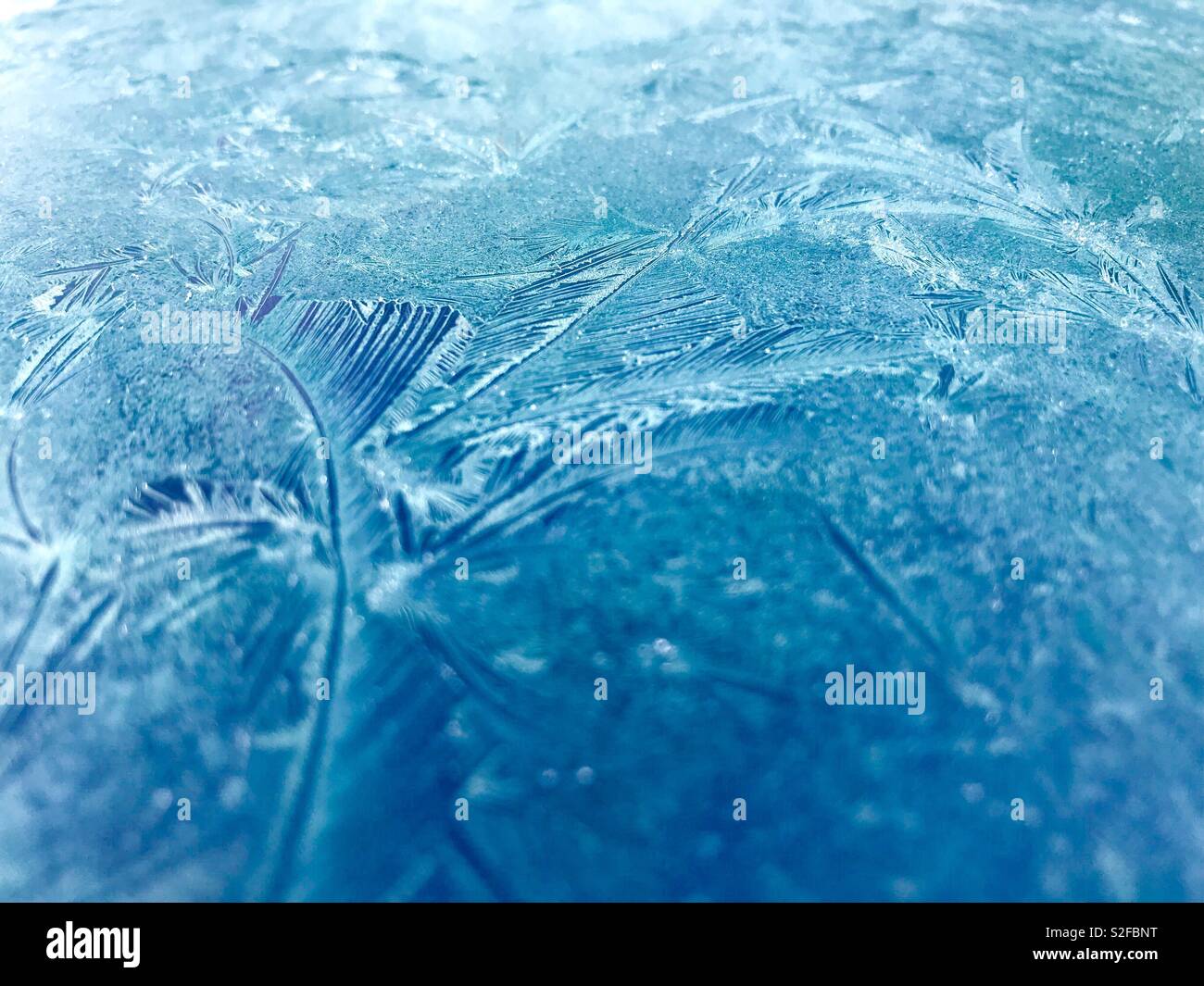 Ice formed in blue patterns Stock Photo - Alamy