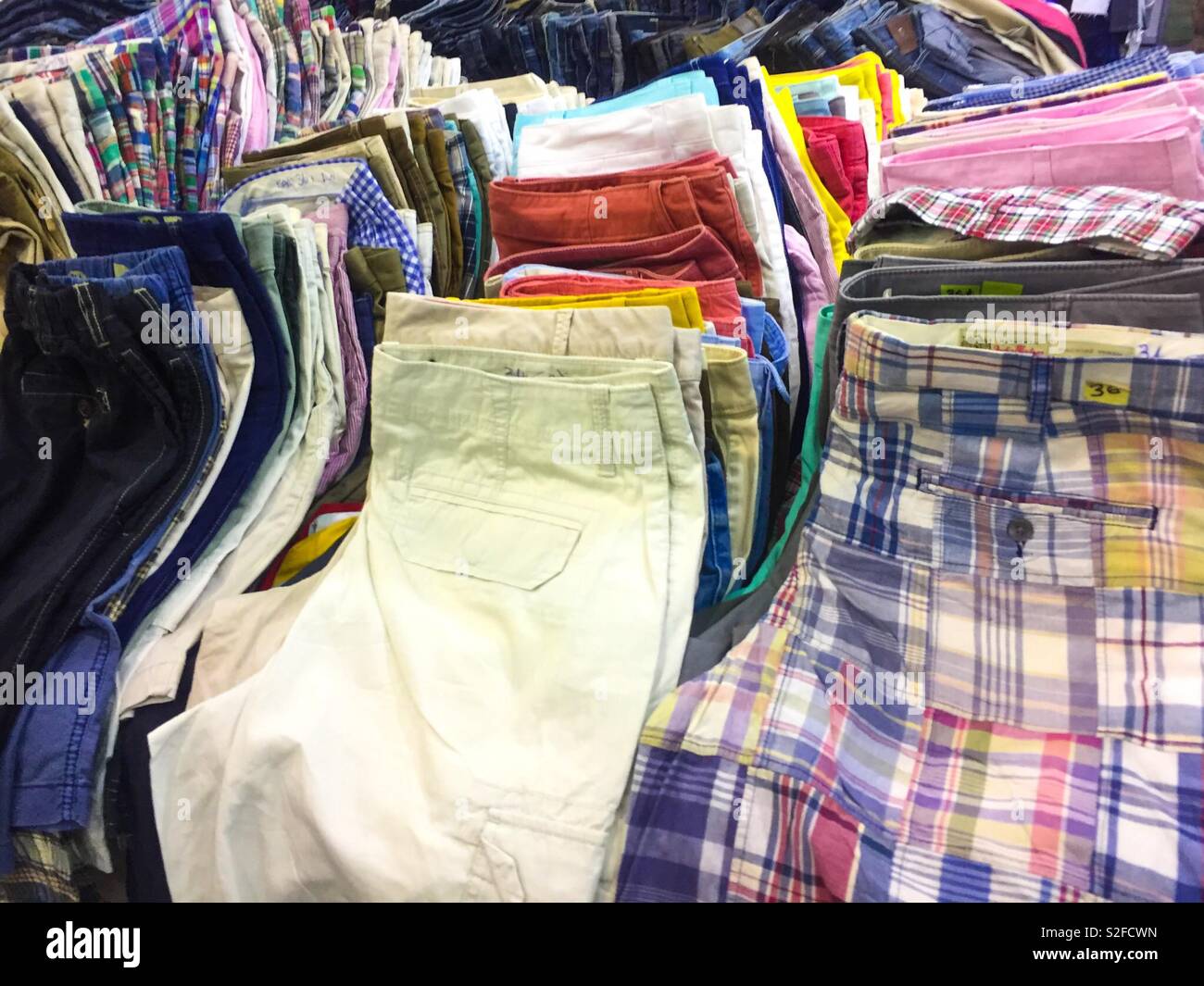 Shorts collection at clothing market Stock Photo - Alamy