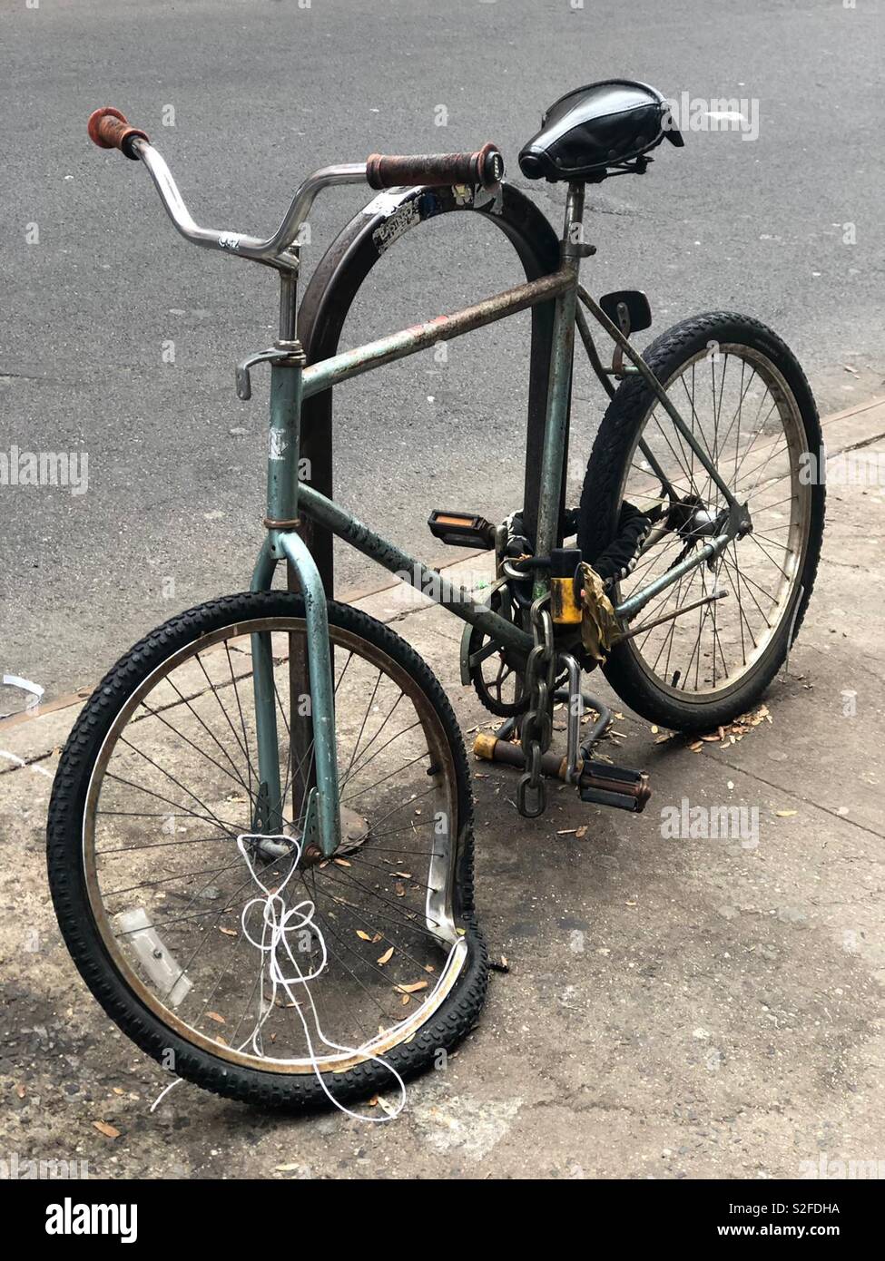 Rusty Bent Bike on Bike Stand Stock Photo - Alamy