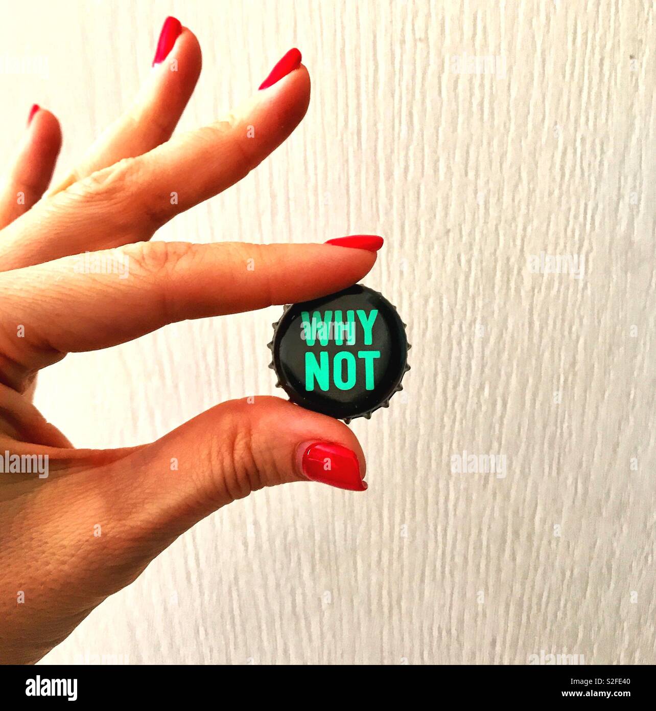 Holding cap with text why not Stock Photo - Alamy