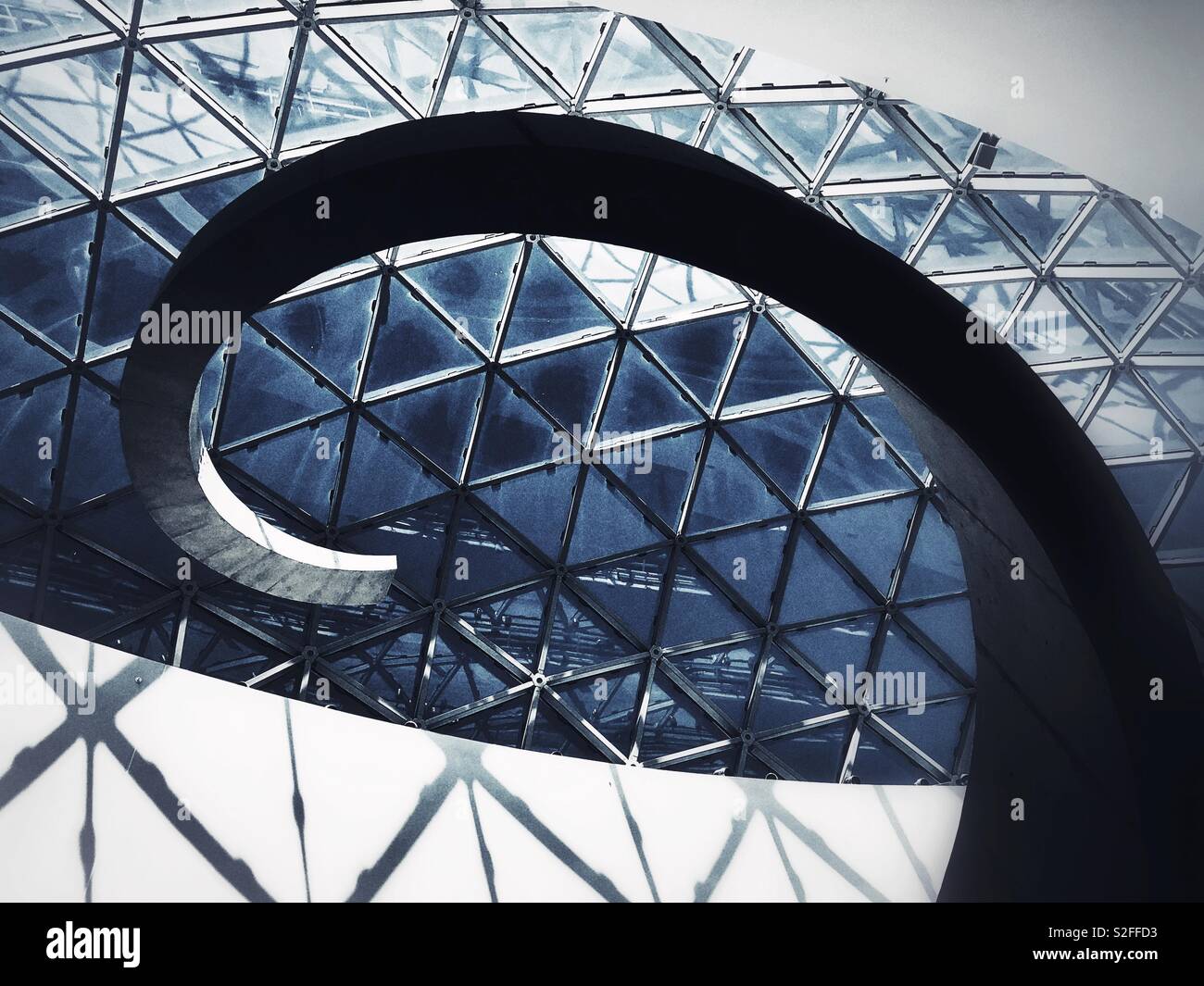 An original glass interior with a unique spiral staircase in Salvador ...
