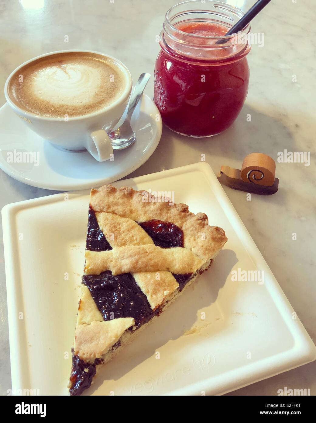 Healthy breakfast time with a cappuccino, prune tart and a centrifuged ...