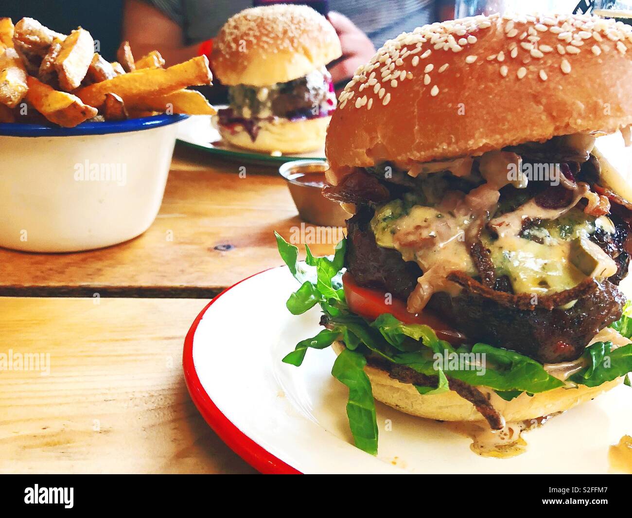 Bacon blue cheese burger and fries Stock Photo - Alamy