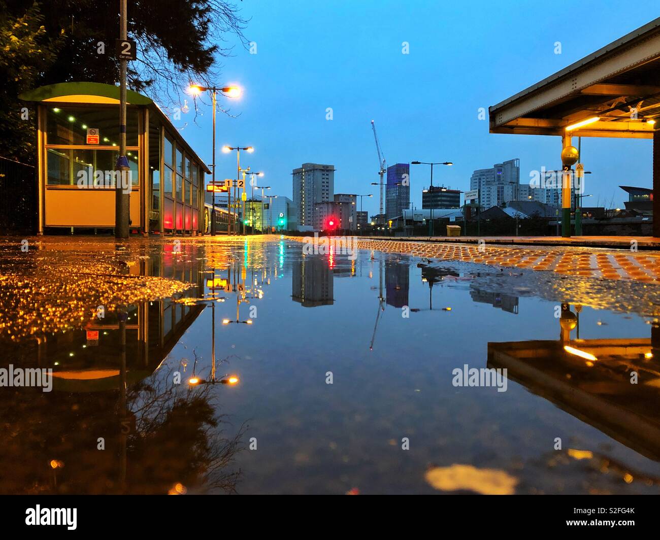 Reflections in a rain puddle on a train platform, Cardiff Stock Photo ...