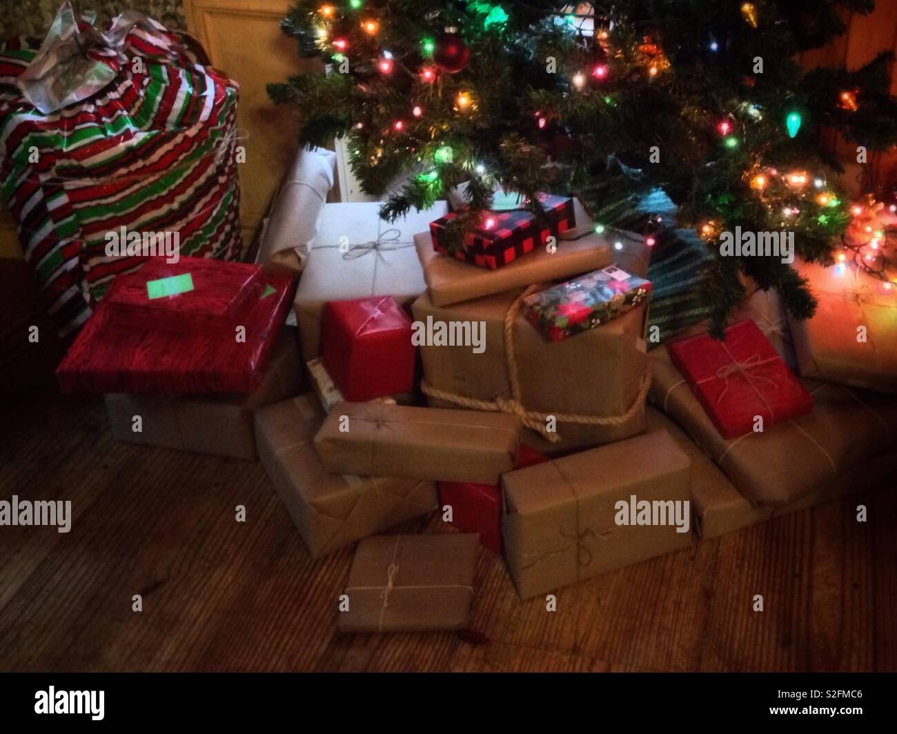 Christmas presents wrapped and under the tree Stock Photo - Alamy