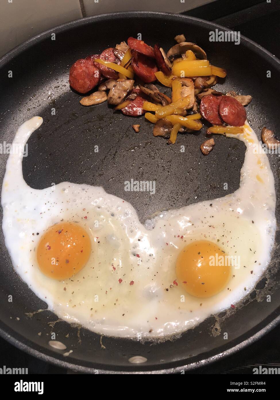 Egg breakfast cooking in pan Stock Photo - Alamy