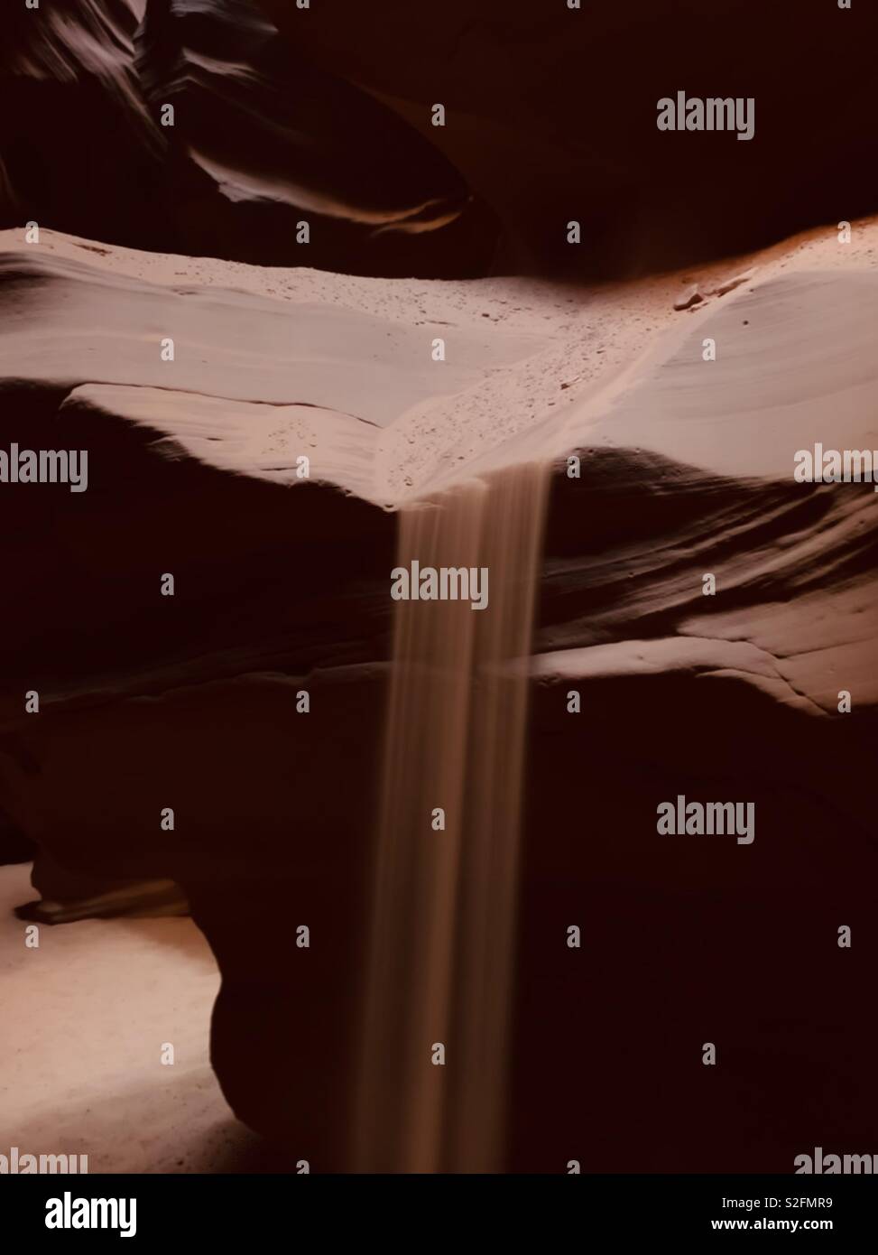 Enjoy this picture of a long exposure shot of sand falling off a rock ...