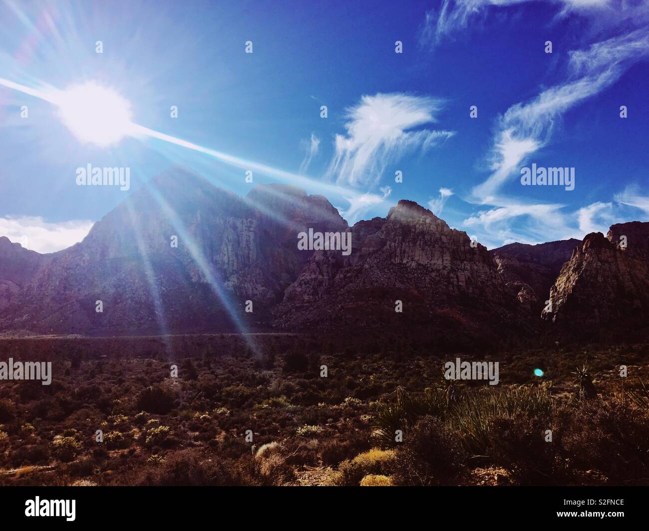 Bright sun shining above mountain in a deserted area Stock Photo - Alamy