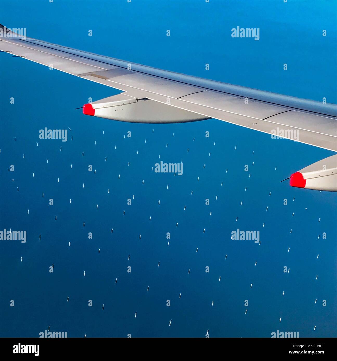 Aerial view of white turbines in a huge wind farm in the English ...