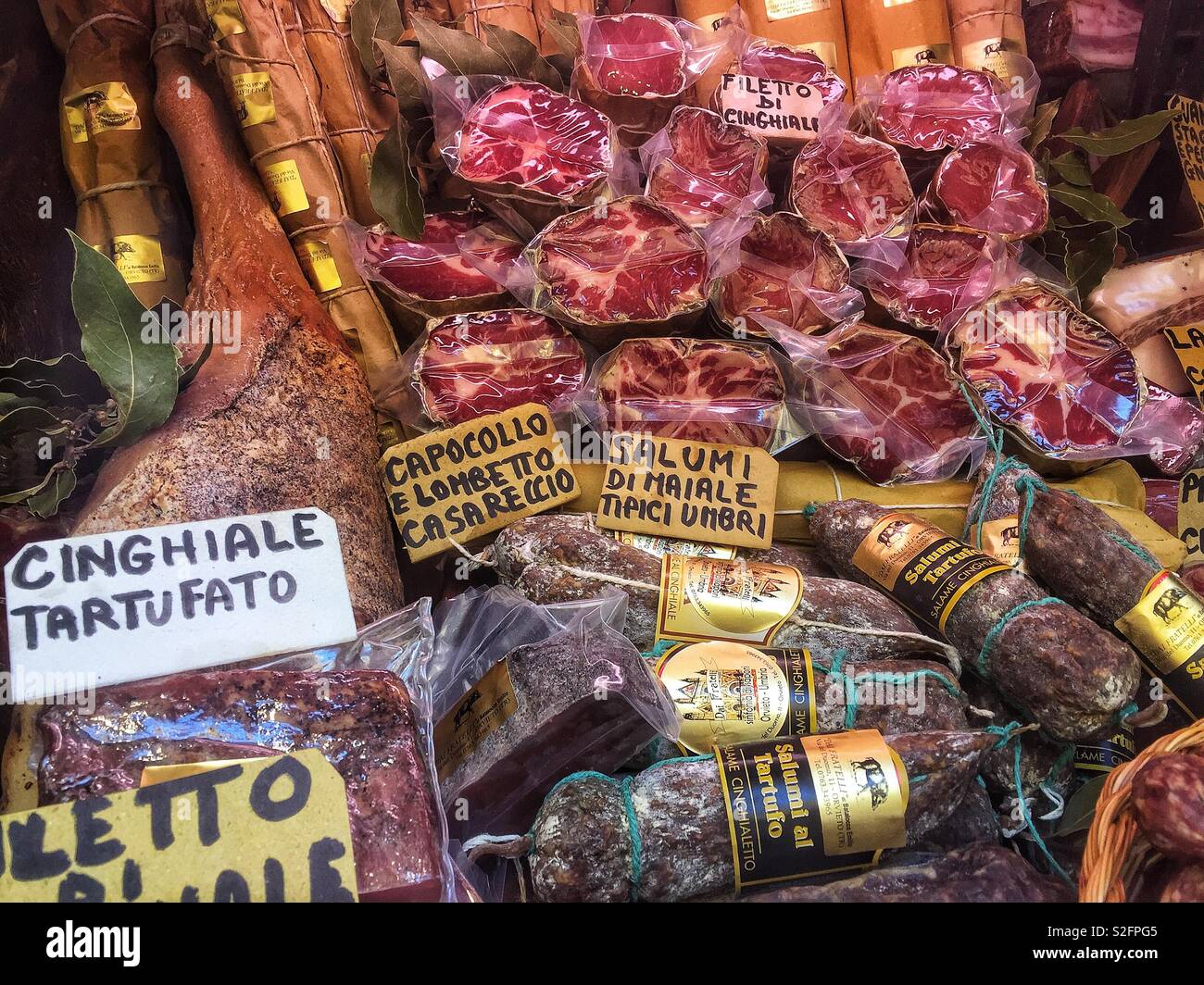 Italian salamis and preserved meats on display at a delicatessen ...