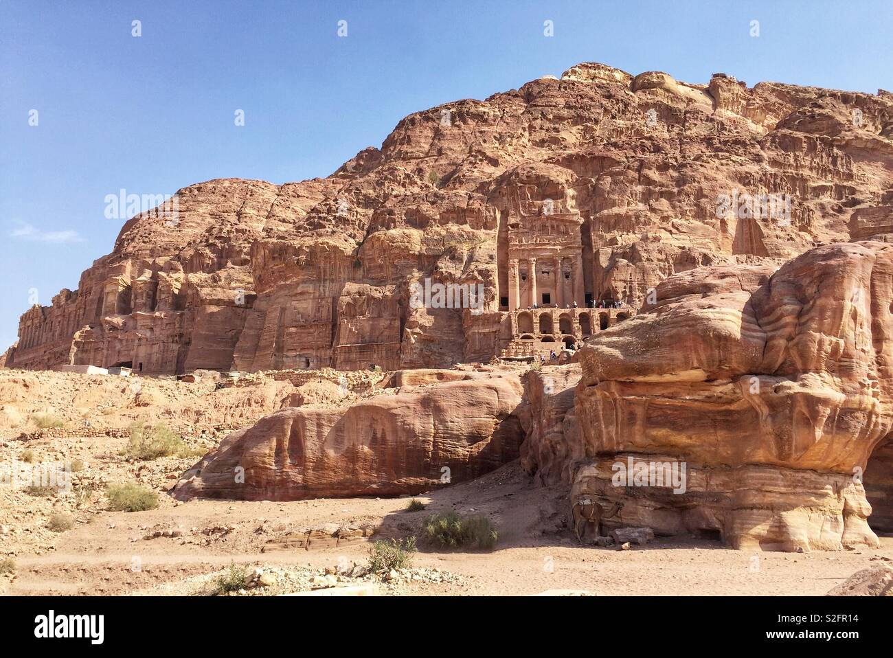 Tourists exploring Tombs and Temples carved out of Sandstone Rock by ...