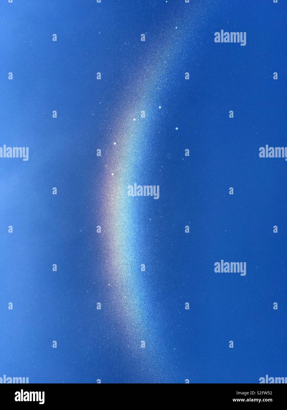 Ice crystals in the air act as a prism to create a rainbow arc Stock ...