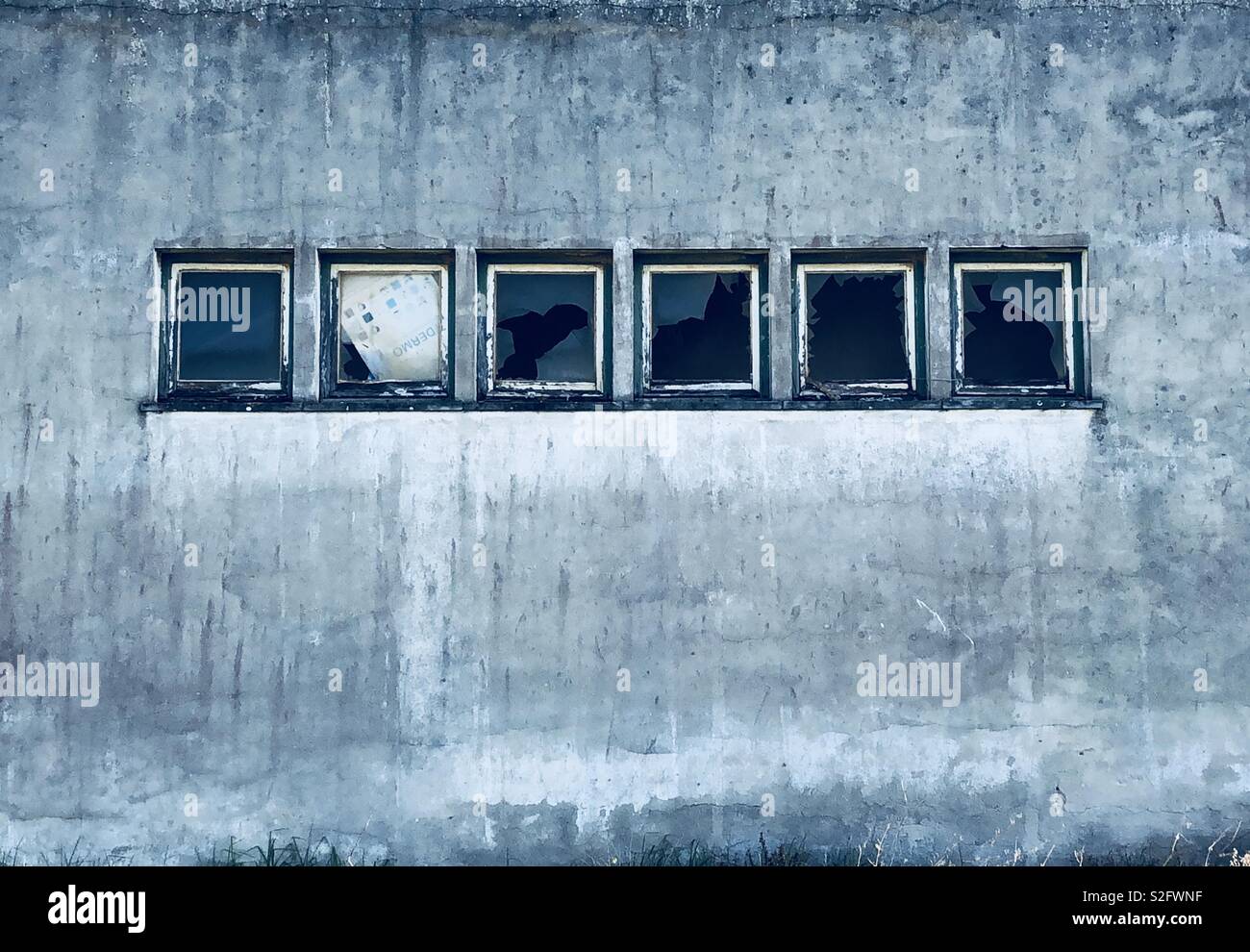Broken windows in an abandoned building Stock Photo - Alamy