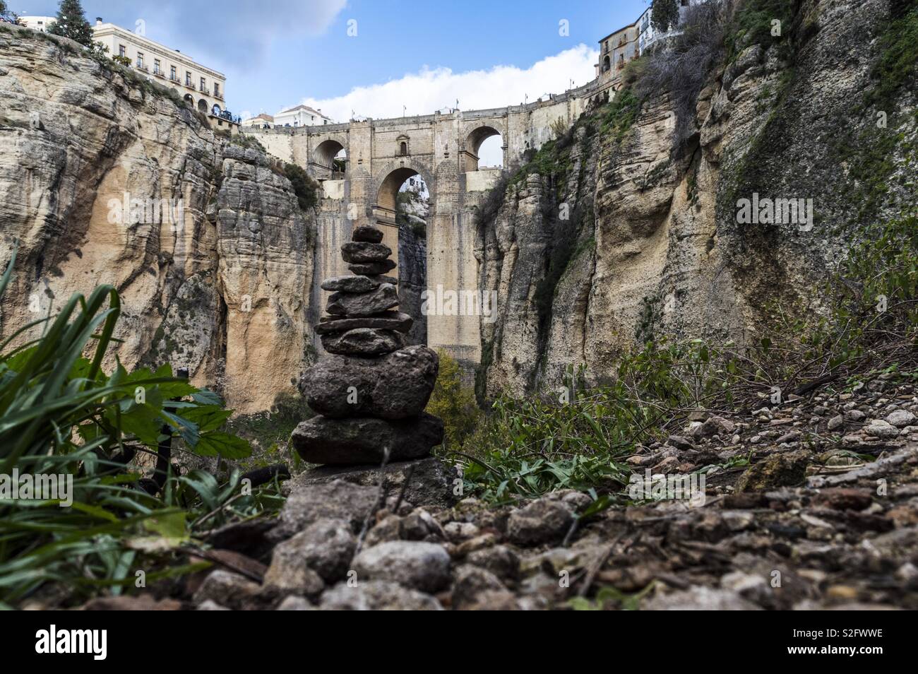 Old bridge in Ronda Spain from the river with rocks pyramid Stock Photo ...