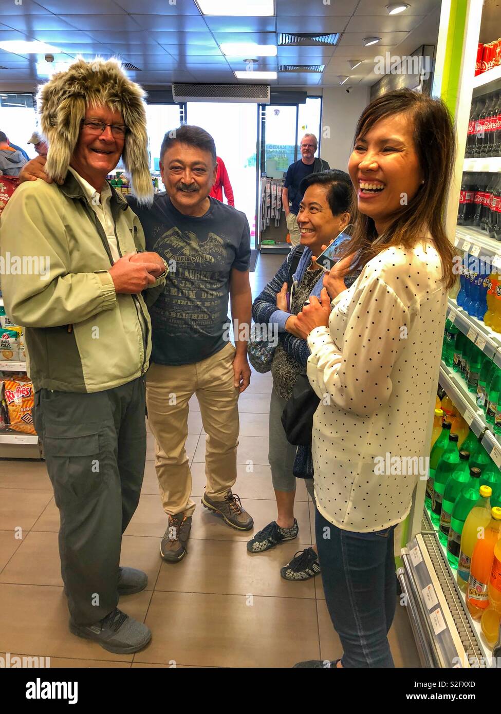 Tourists joking around in a roadside convenience store Stock Photo - Alamy