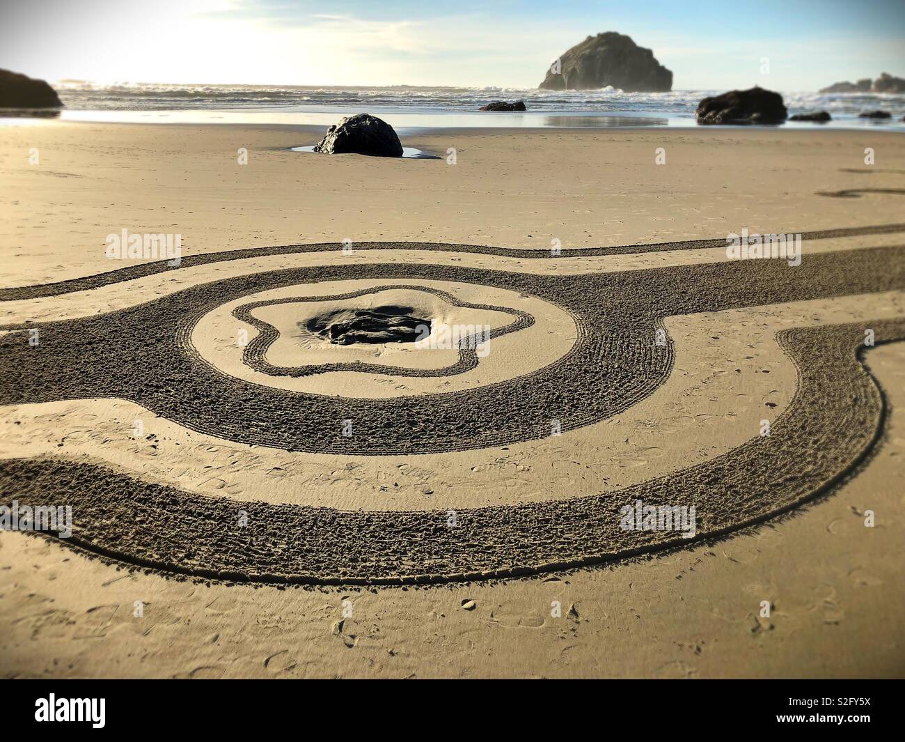 A detail of a sand labyrinth on Face Rock beach in Bandon, Oregon, USA ...