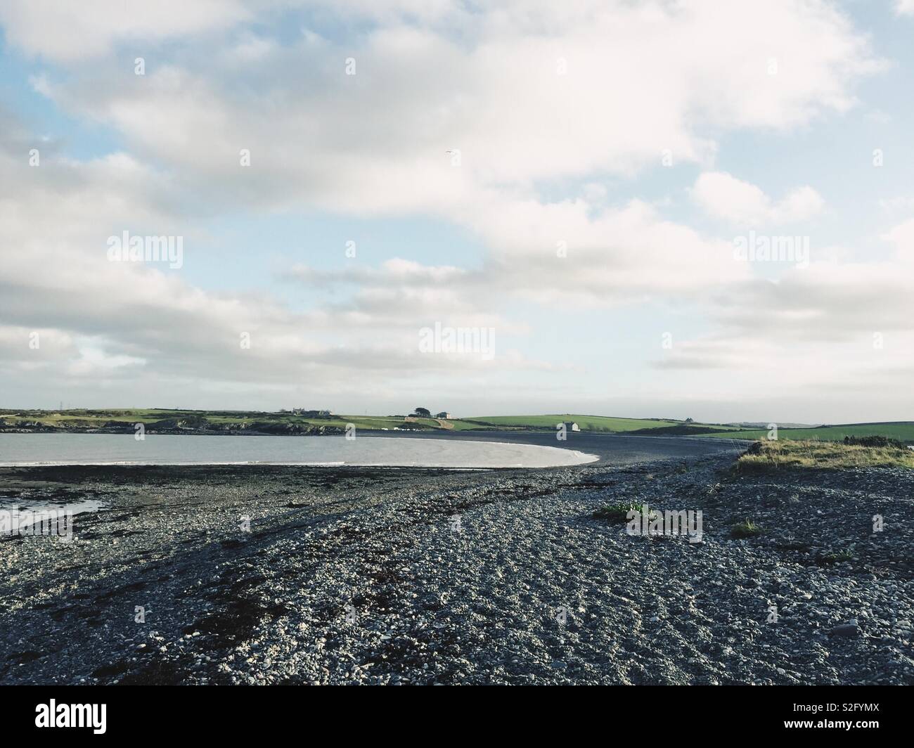 View across the shingle beach of Cemlyn Bay, Anglesey, North Wales ...