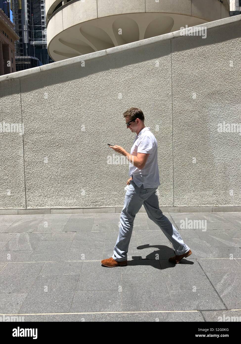 Mobile phone walking man Stock Photo - Alamy