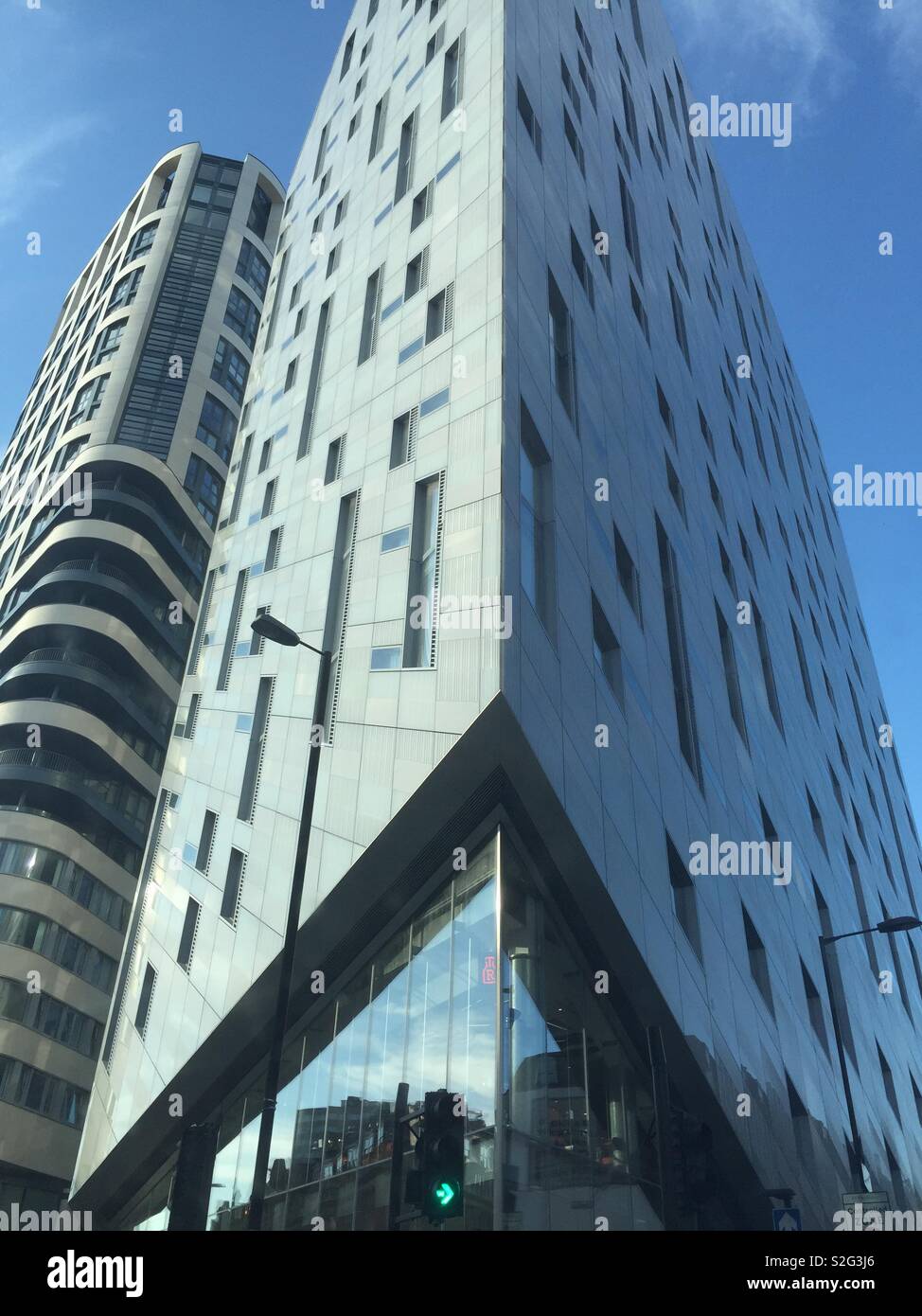 Modern pointy skyscraper in the sunny city Stock Photo - Alamy