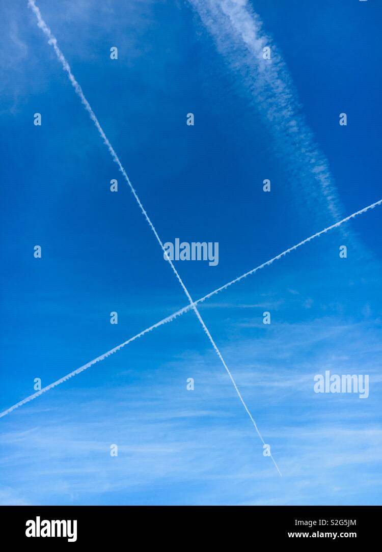 Blue sky and contrails Stock Photo - Alamy