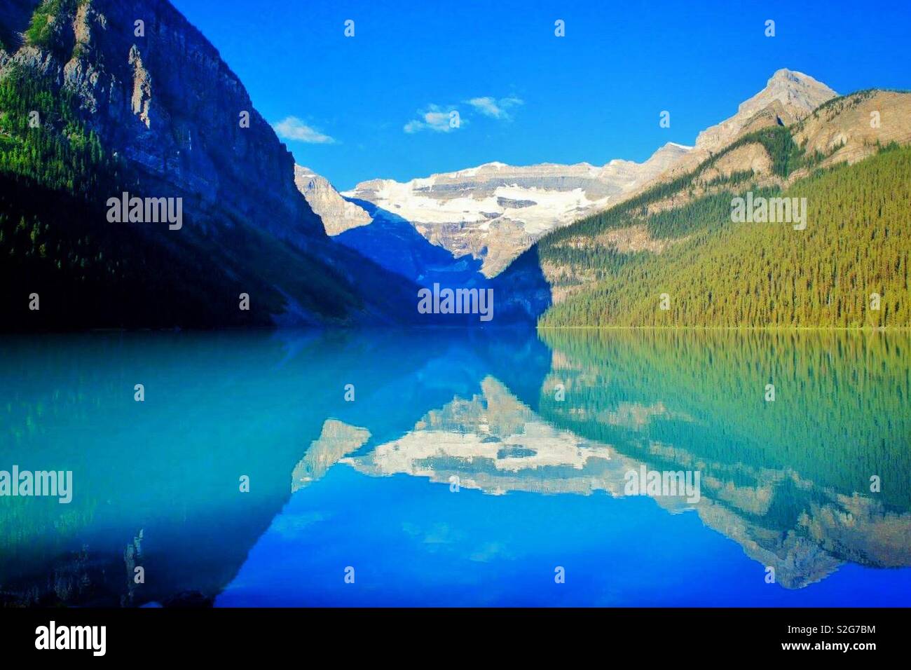 Reflection of Louise lake in Banff, early morning sunrise Stock Photo ...