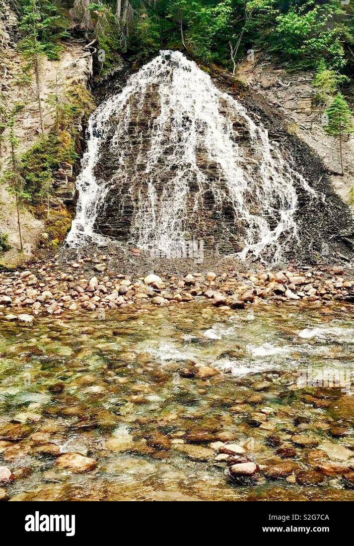 Spread waterfall continuing downstream Stock Photo - Alamy