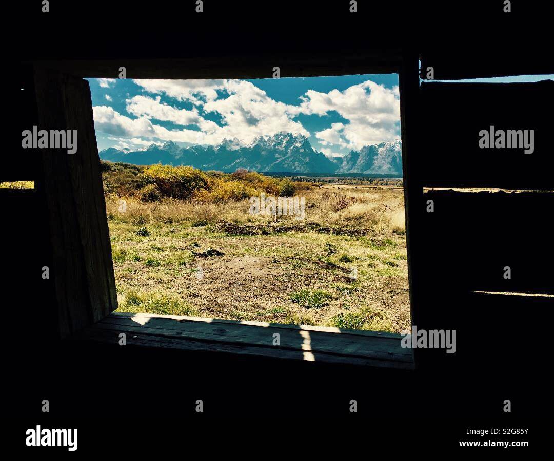 View of the Grand Teton mountains as seen through the window of a ...