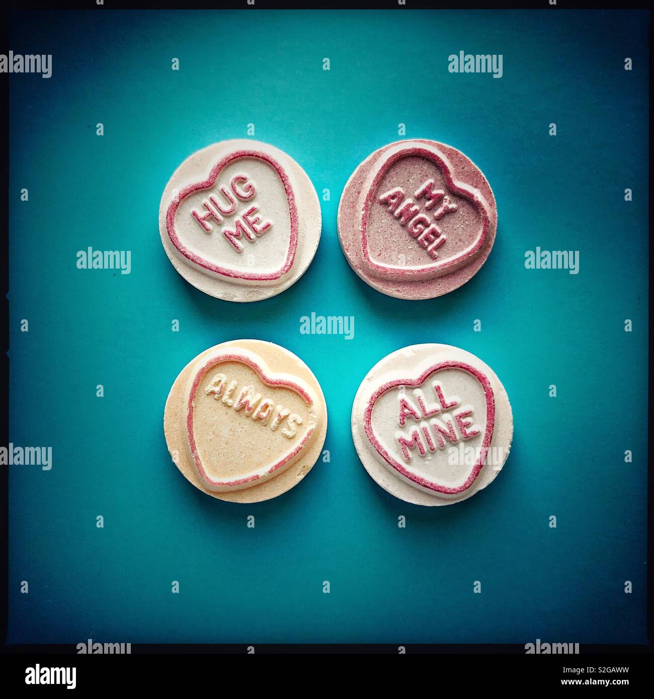 Four love heart sweets together Stock Photo - Alamy