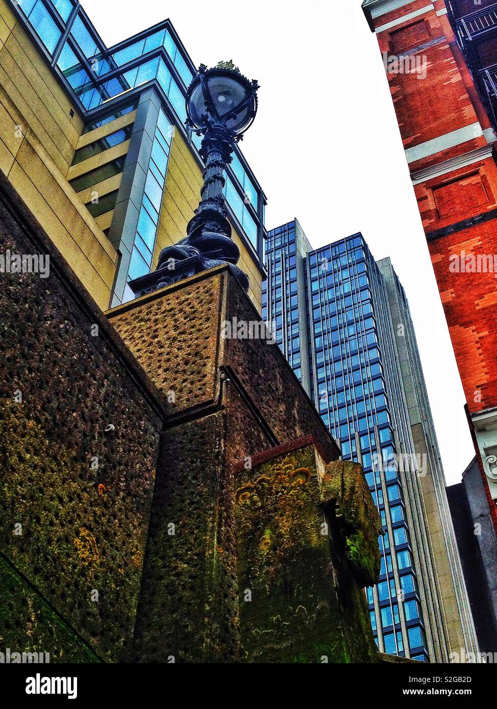 The old and the new. View of the Victorian river Thames Embankment wall ...