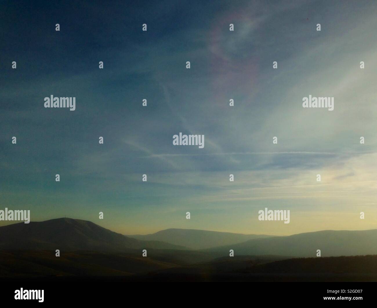 Cascade Mountain foothills at twilight, as seen through car window ...