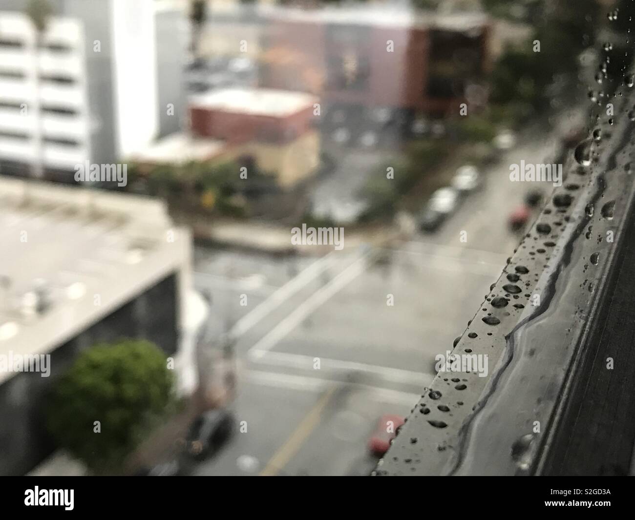 Raindrops on the window sill of a high rise building are shown during a ...