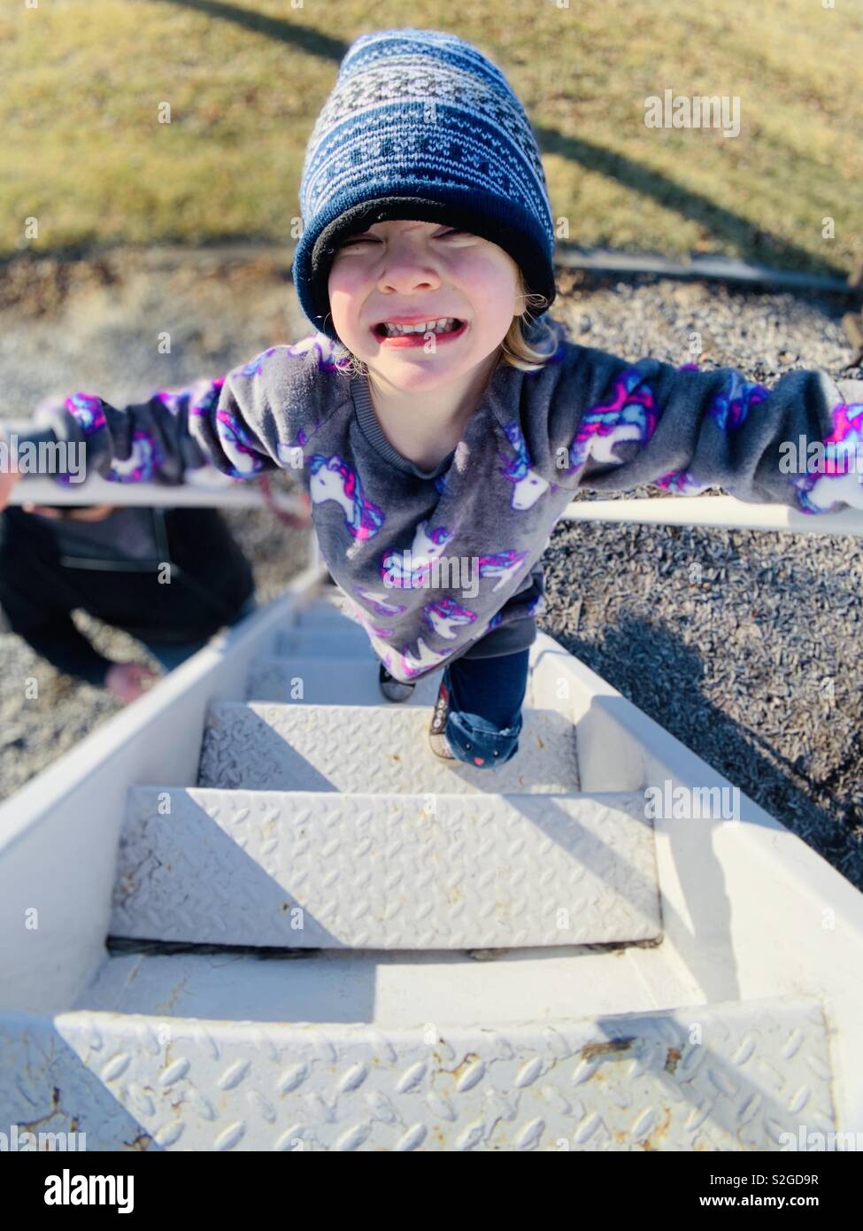 Young child playing at the playground smiling at camera Stock Photo - Alamy