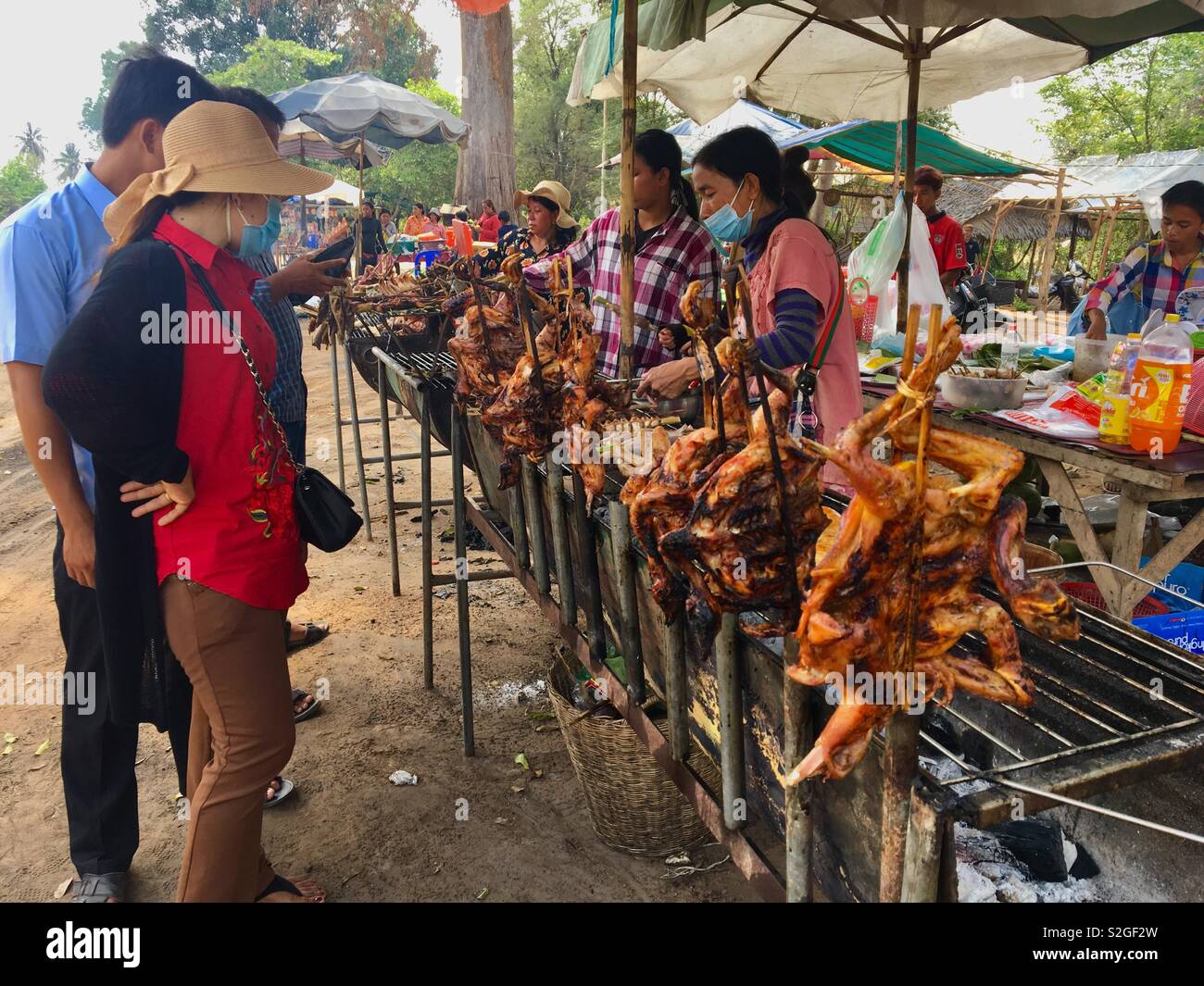 Street food market with chickens being charcoaled in Cambodia Stock ...