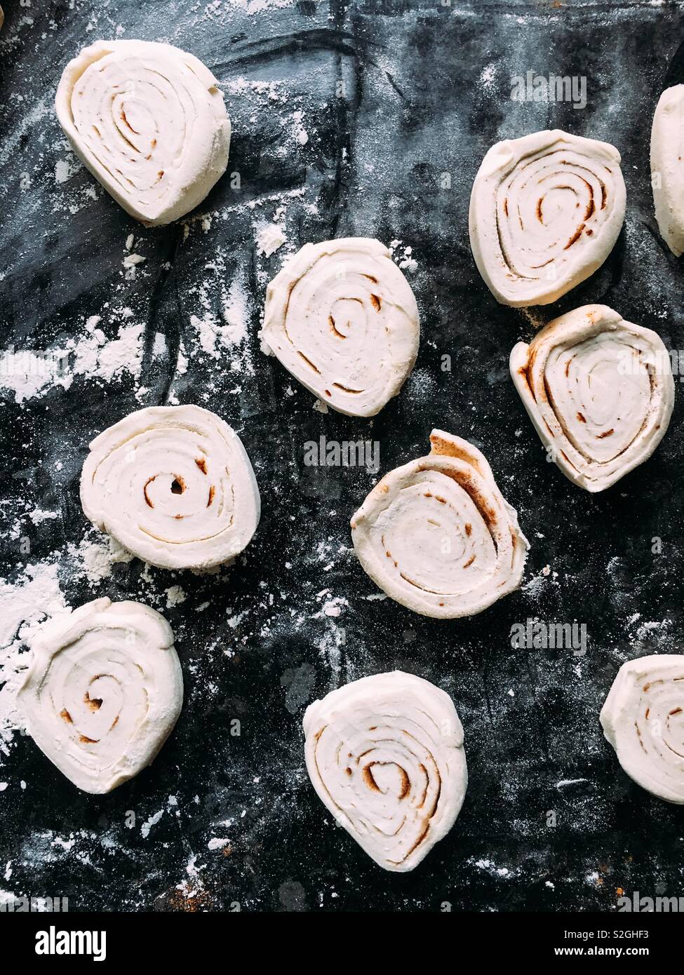 Making pastry cases with a cinnamon dusting Stock Photo - Alamy