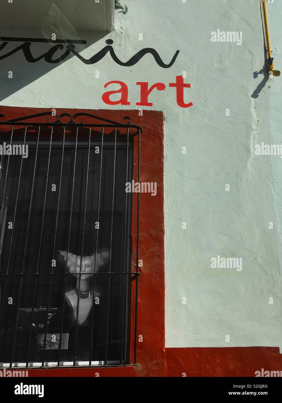 Surreal display behind wrought iron clad window, art signage Stock ...