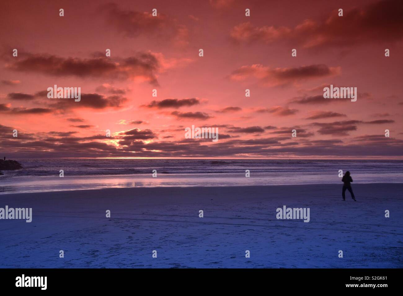 Red and blue sunset on the beach Stock Photo - Alamy