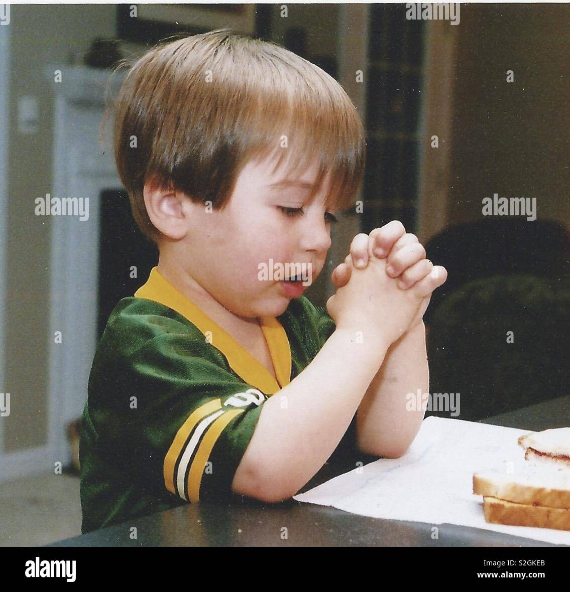 Male toddler praying over a sandwich Stock Photo - Alamy