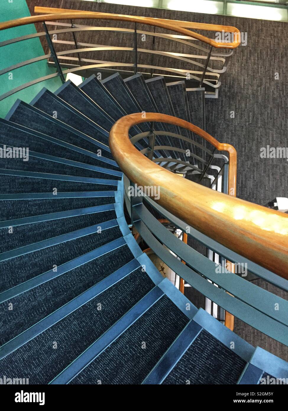 A spiral staircase in an office Stock Photo - Alamy