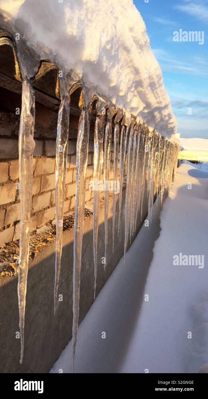 Winter icicles covered roof porch Stock Photo - Alamy