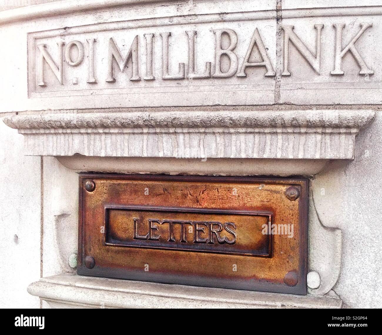 A brass letterbox on an office building in Millbank, London, England ...