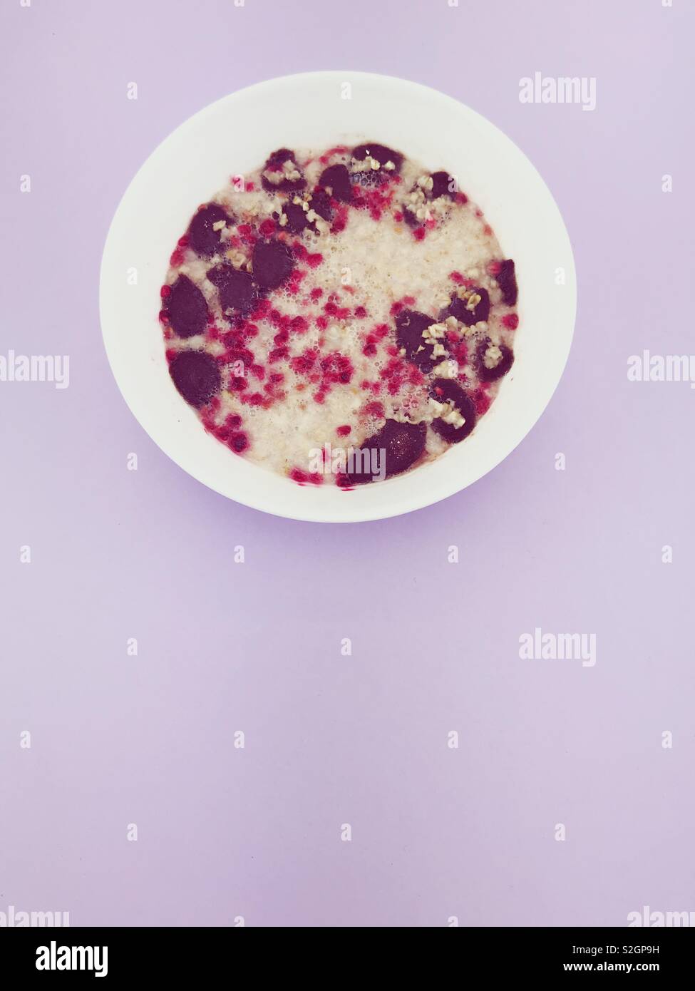 red fruits muesli in a white bowl Stock Photo - Alamy