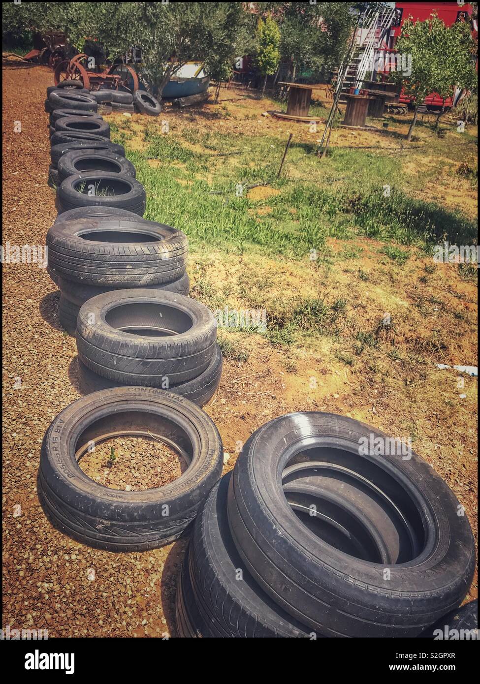 Old used rubber tyres along path at Toeka Stoor in Windmeul near Paarl ...